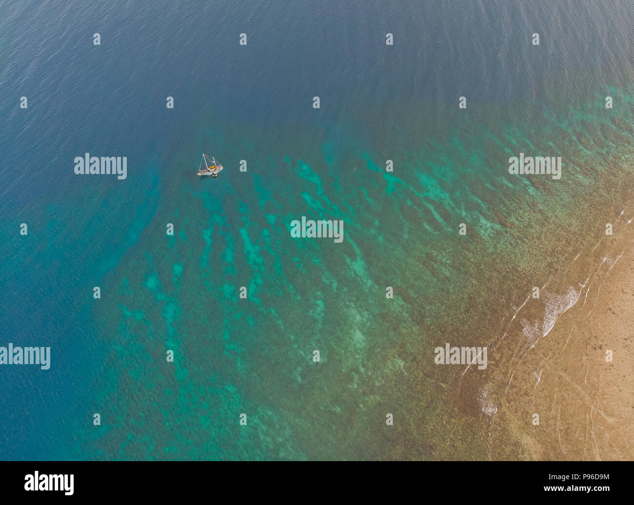 Sailboat Over Coral Reef In The Caribbean Stock Photo - Alamy