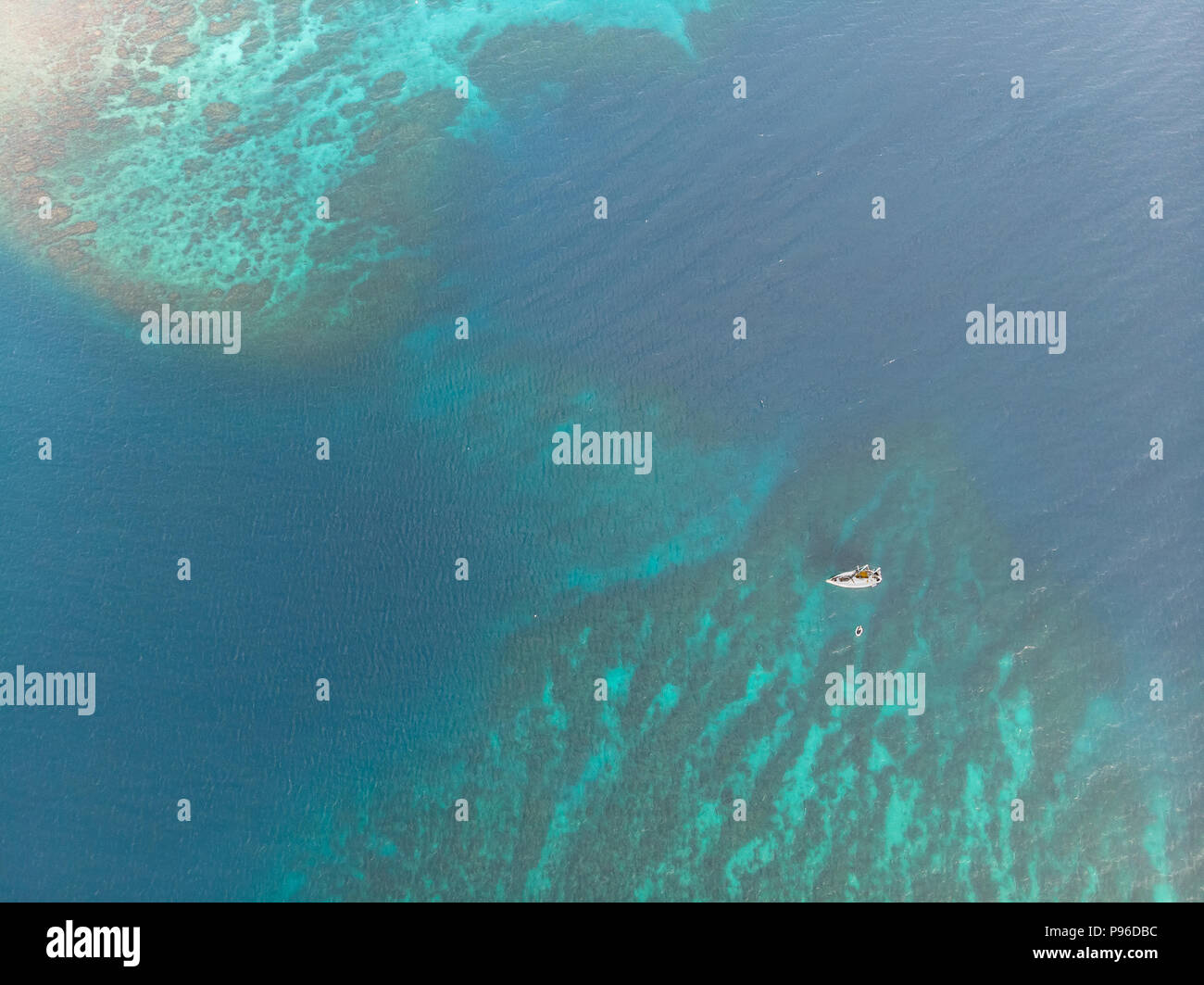Sailboat Over Coral Reef In The Caribbean Stock Photo - Alamy