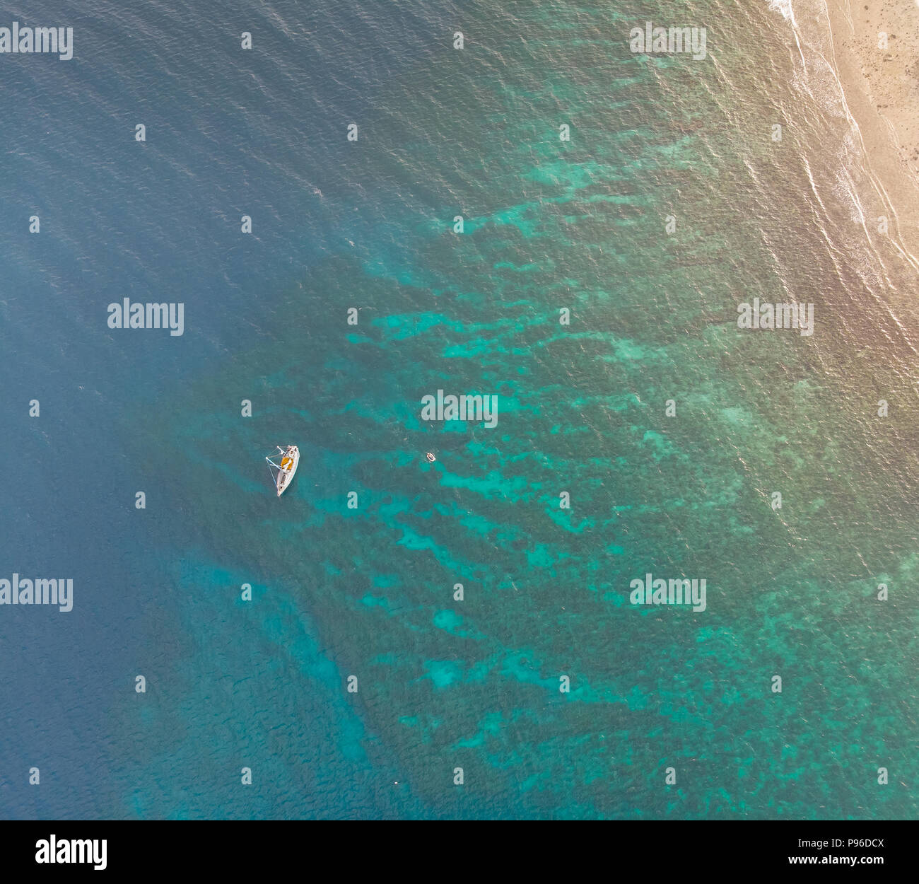 Sailboat Over Coral Reef In The Caribbean Stock Photo - Alamy