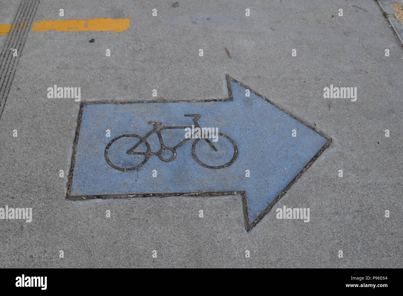Blue arrow for bike path Stock Photo - Alamy