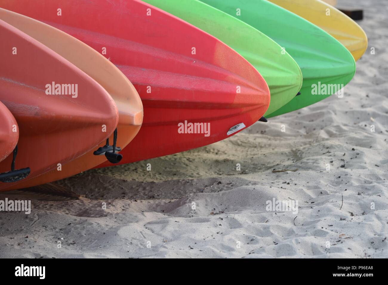 Colorful kayaks on the beach Stock Photo - Alamy