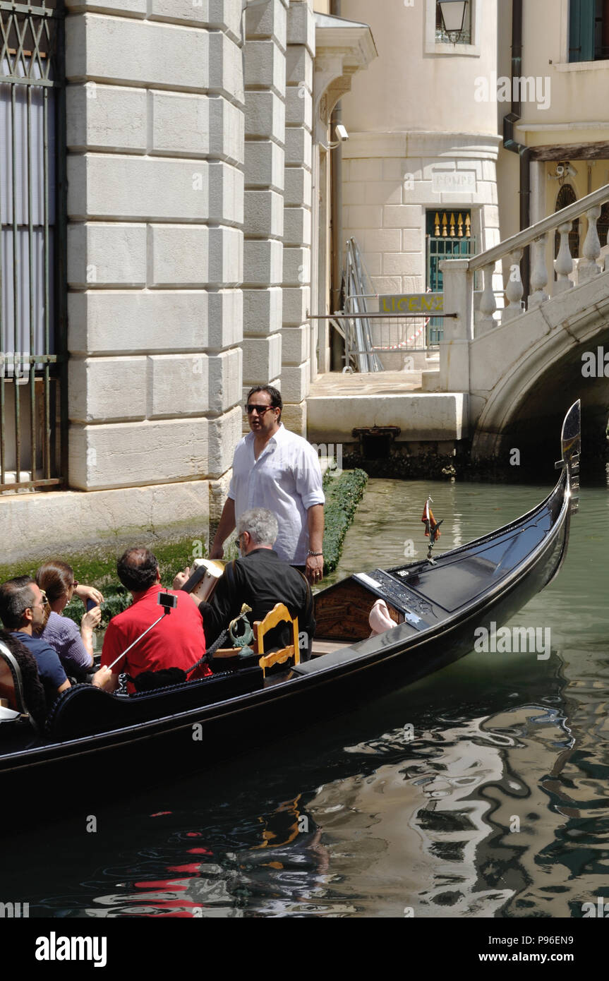 A gondola with singer and accordionist on a quiet canal in Venice Stock ...