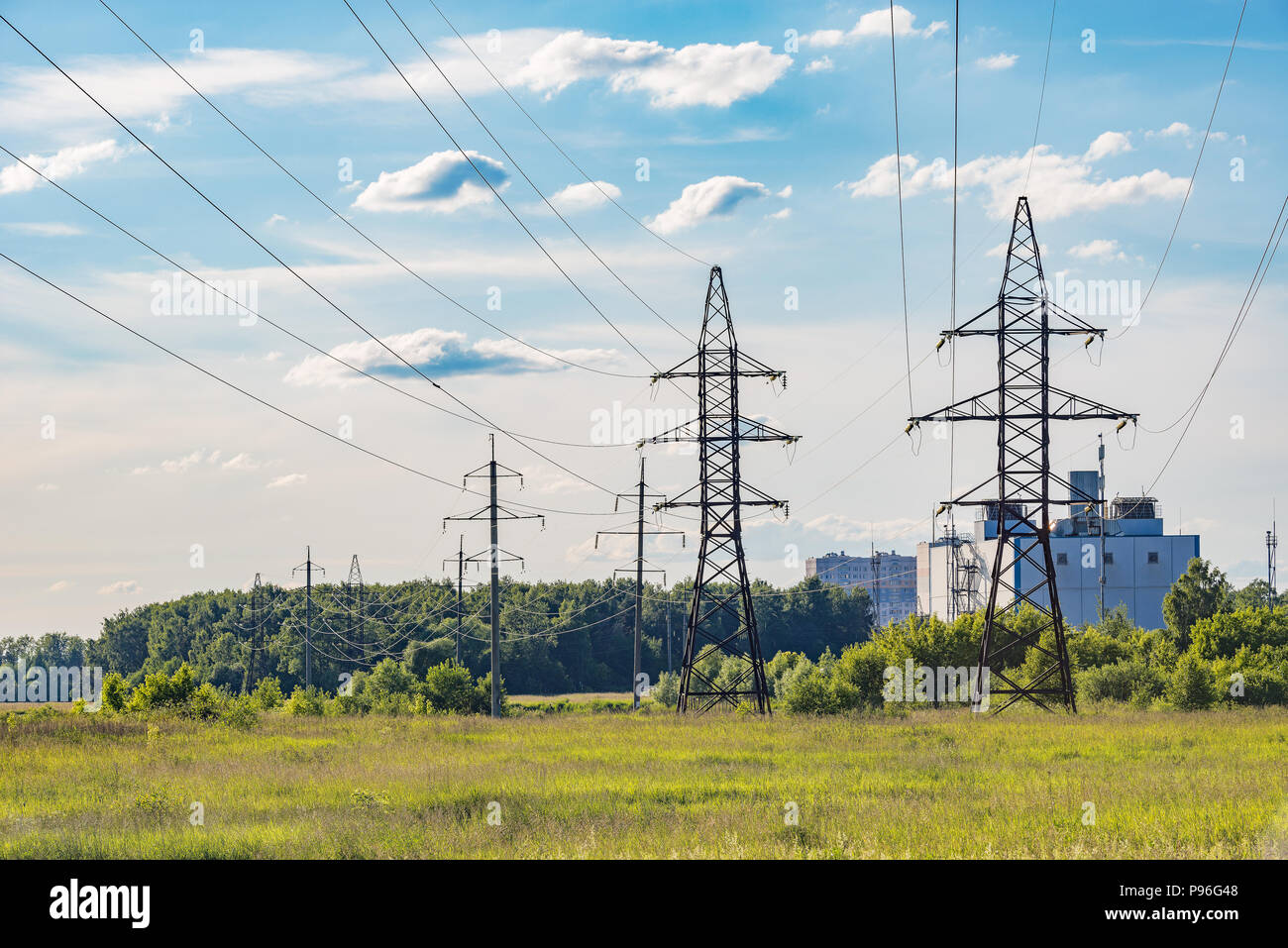 High-voltage towers and small power station at evening time Stock Photo ...