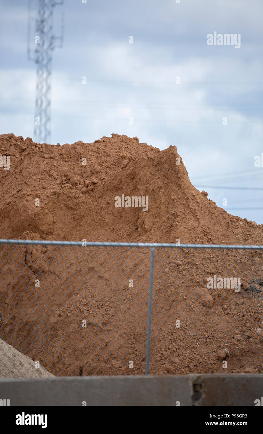 Huge pile of red dirt brought in for construction Stock Photo - Alamy