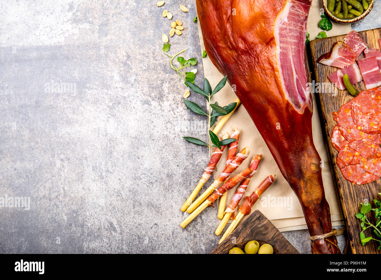 Appetizers table with spanish iberian whole ham jamon serrano, snacks ...