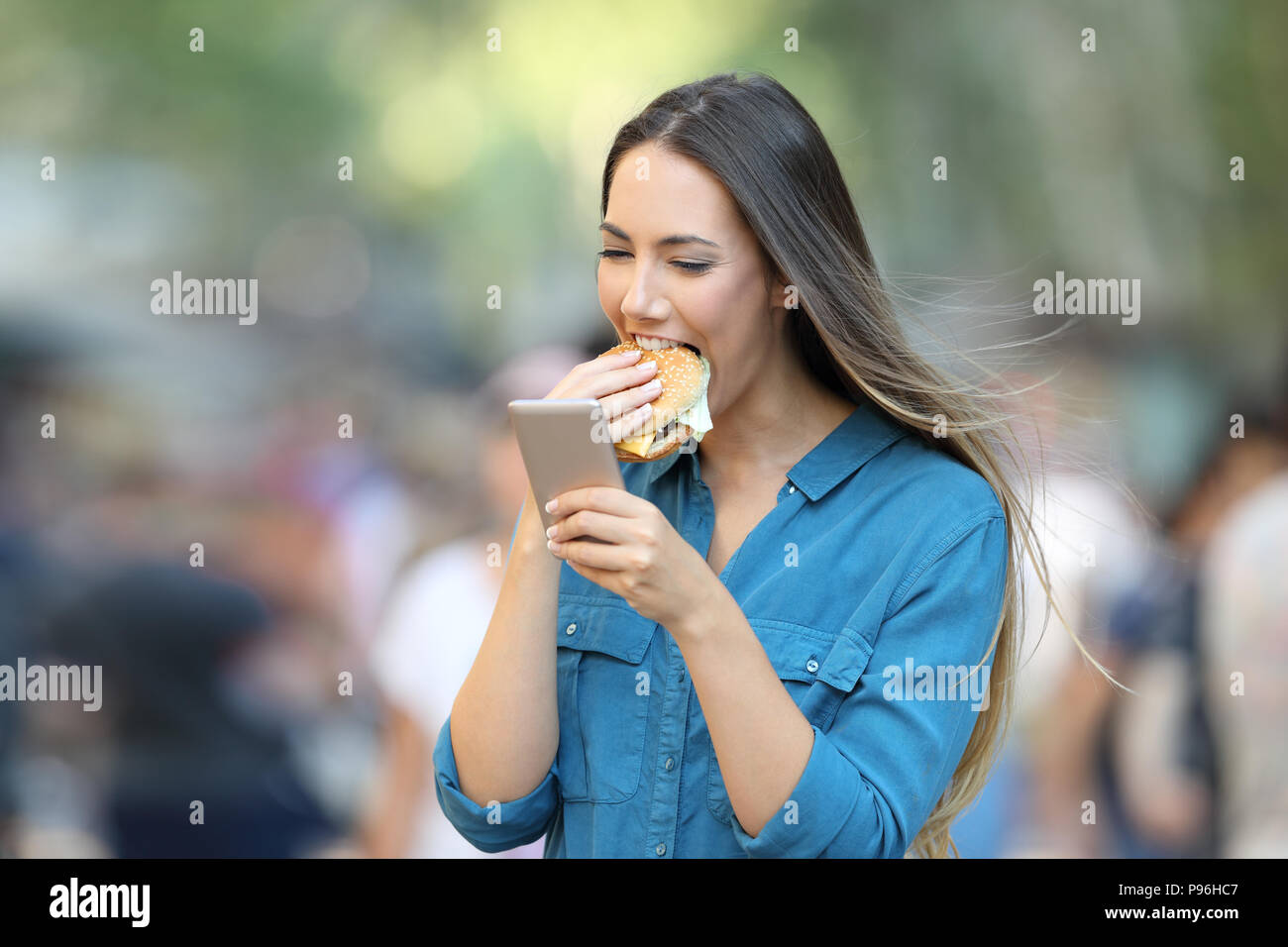 Unhealthy eating on phone hi-res stock photography and images - Alamy