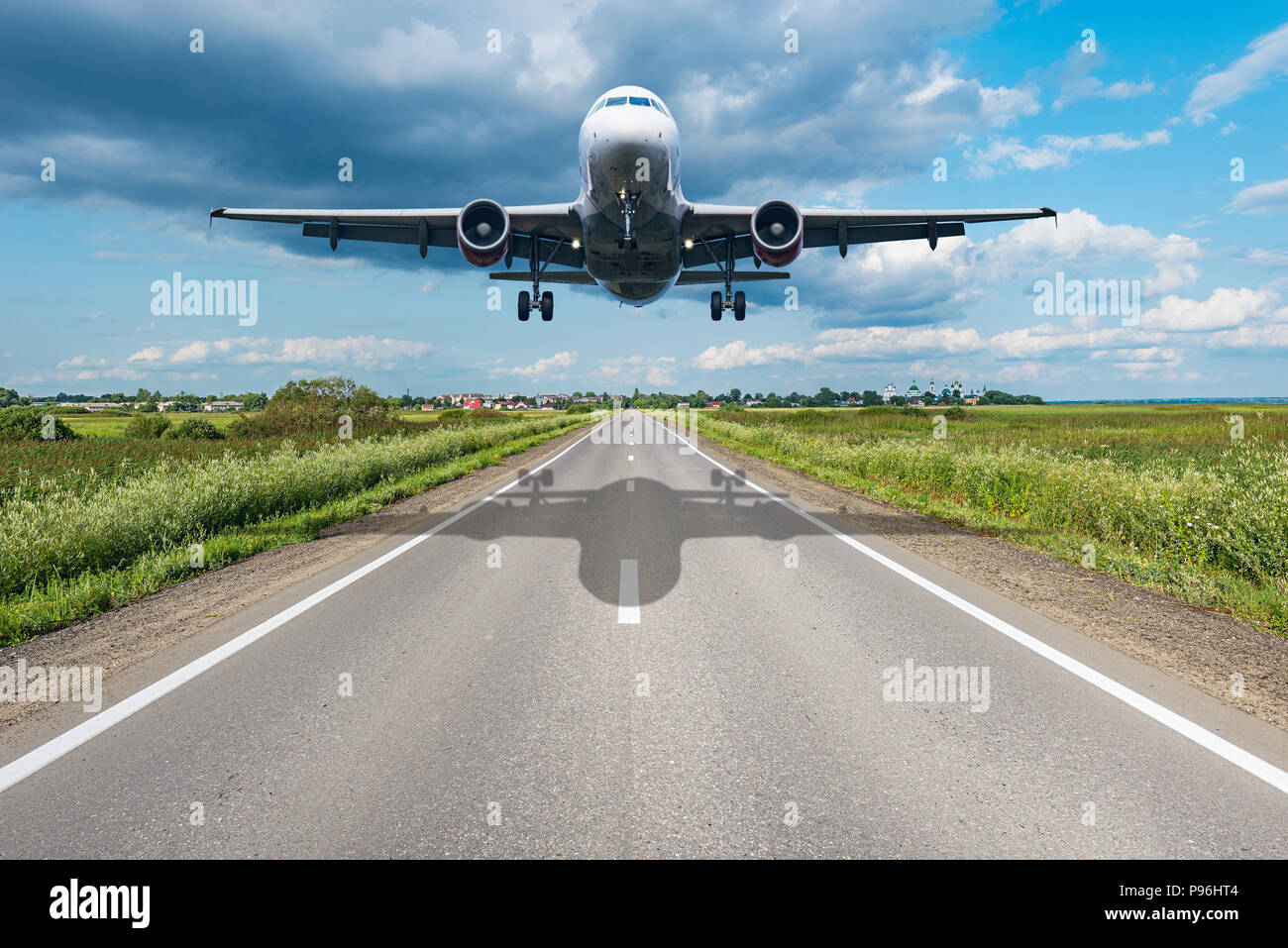 Landing of the passenger plane to the new highway Stock Photo - Alamy