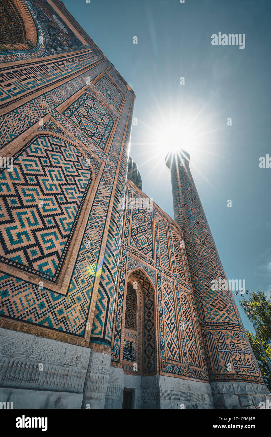 Fragment of Registan Square Minarett with sun and Madrasah complex in ...