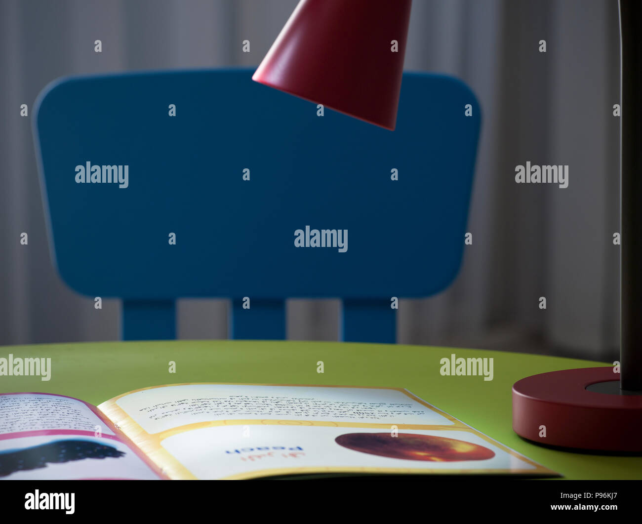 Storybook on a table with a lamp spot light Stock Photo - Alamy