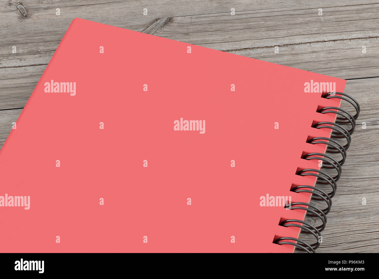 Red spiral notepad isolated on wooden background. Include clipping path ...