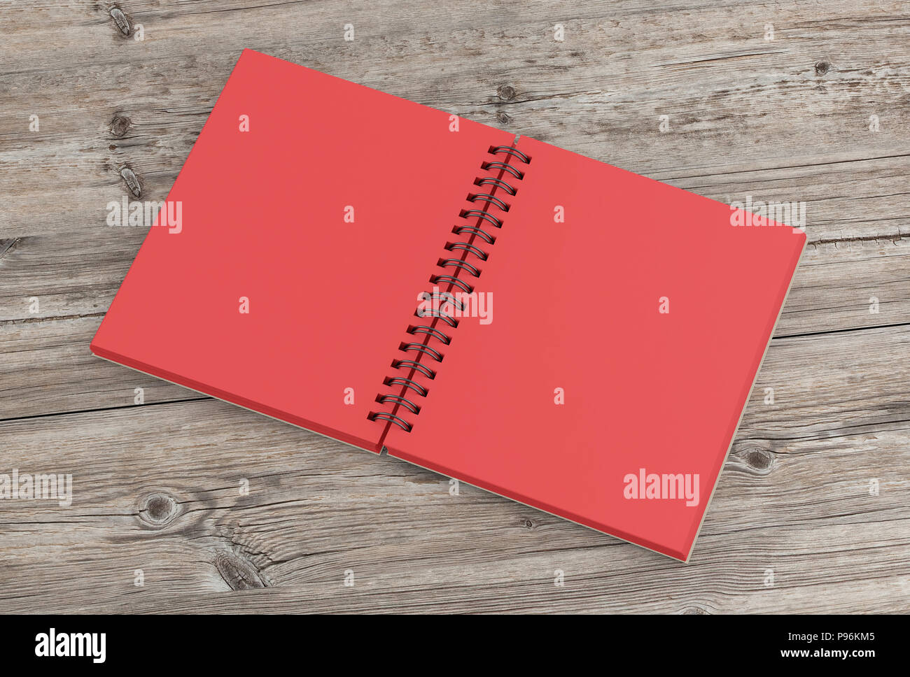 Red spiral notepad isolated on wooden background. Include clipping path ...