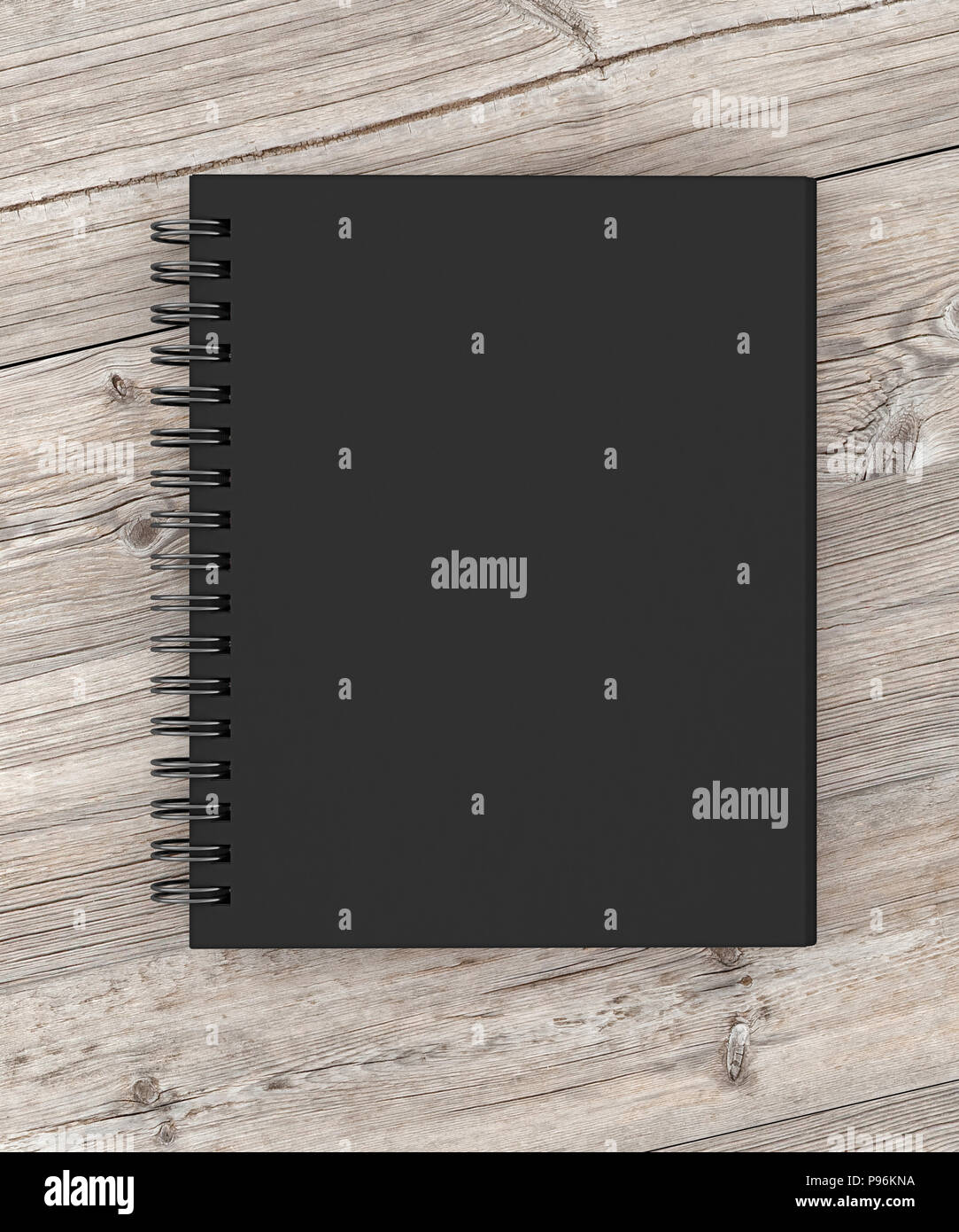 Black spiral notepad isolated on wooden background. Include clipping ...