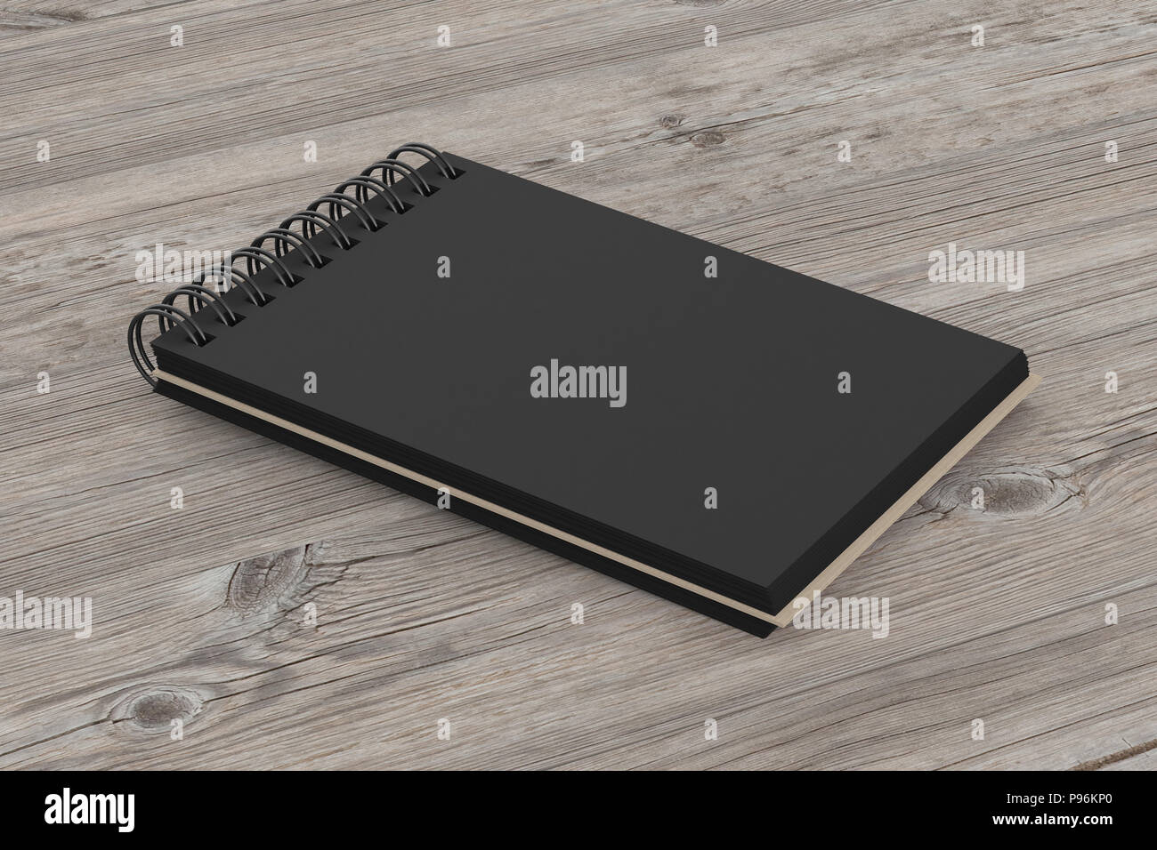 Black spiral notepad isolated on wooden background. Include clipping ...