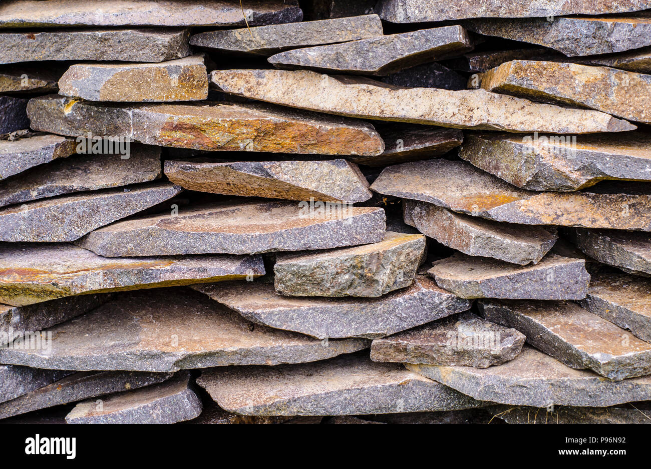 The stones are laid on each other. The textures of different rocks ...