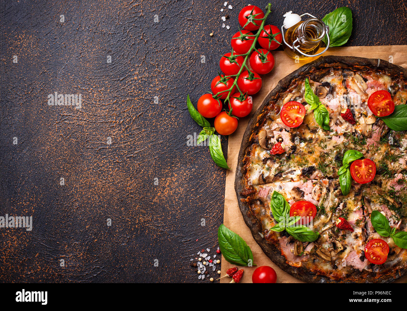Trendy food Italian black pizza Stock Photo - Alamy