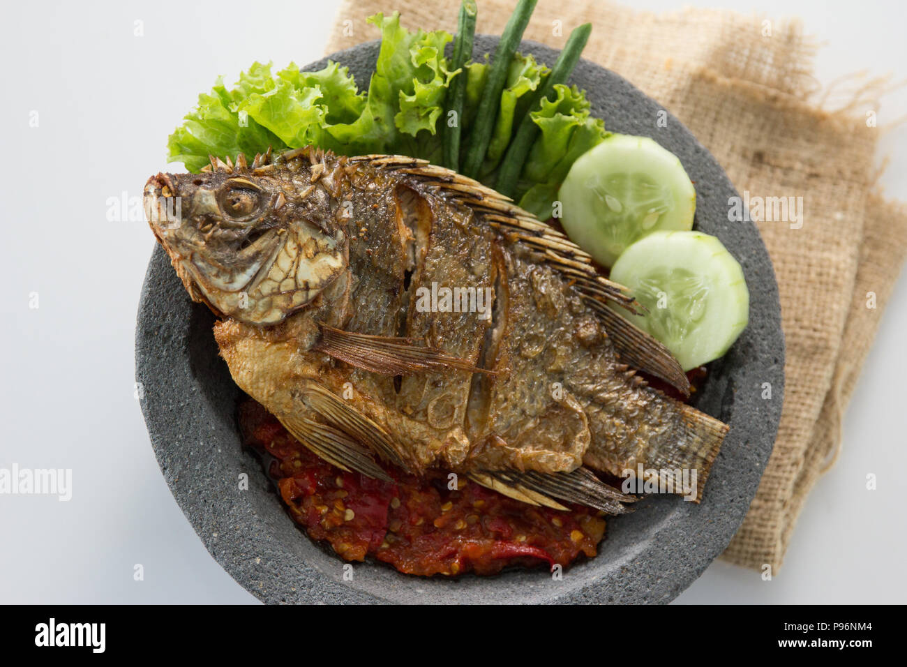 penyetan traditional indonesian food with fish served with spicy sambal ...
