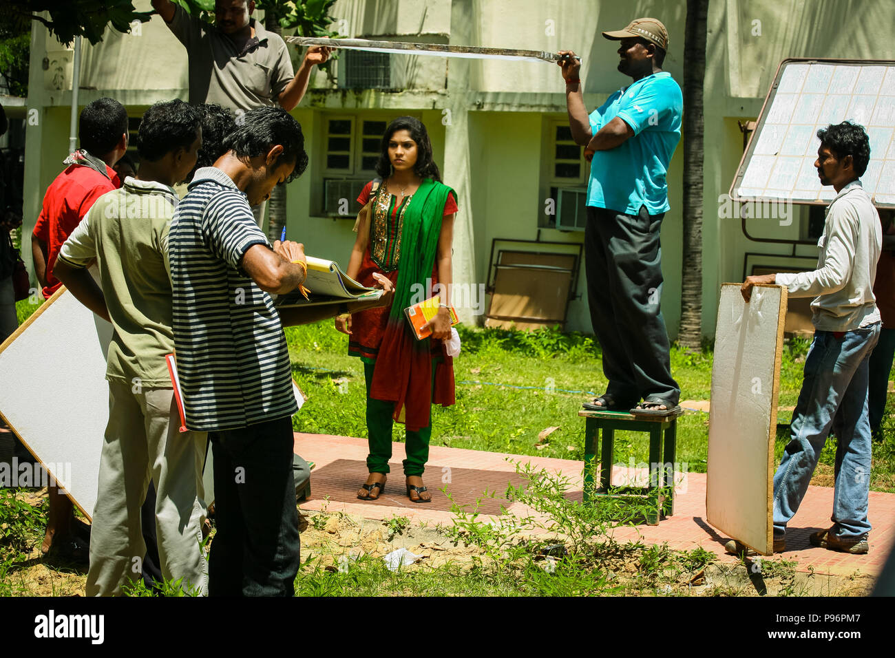Actress in front of the camera on the film set outdoor location. Group ...