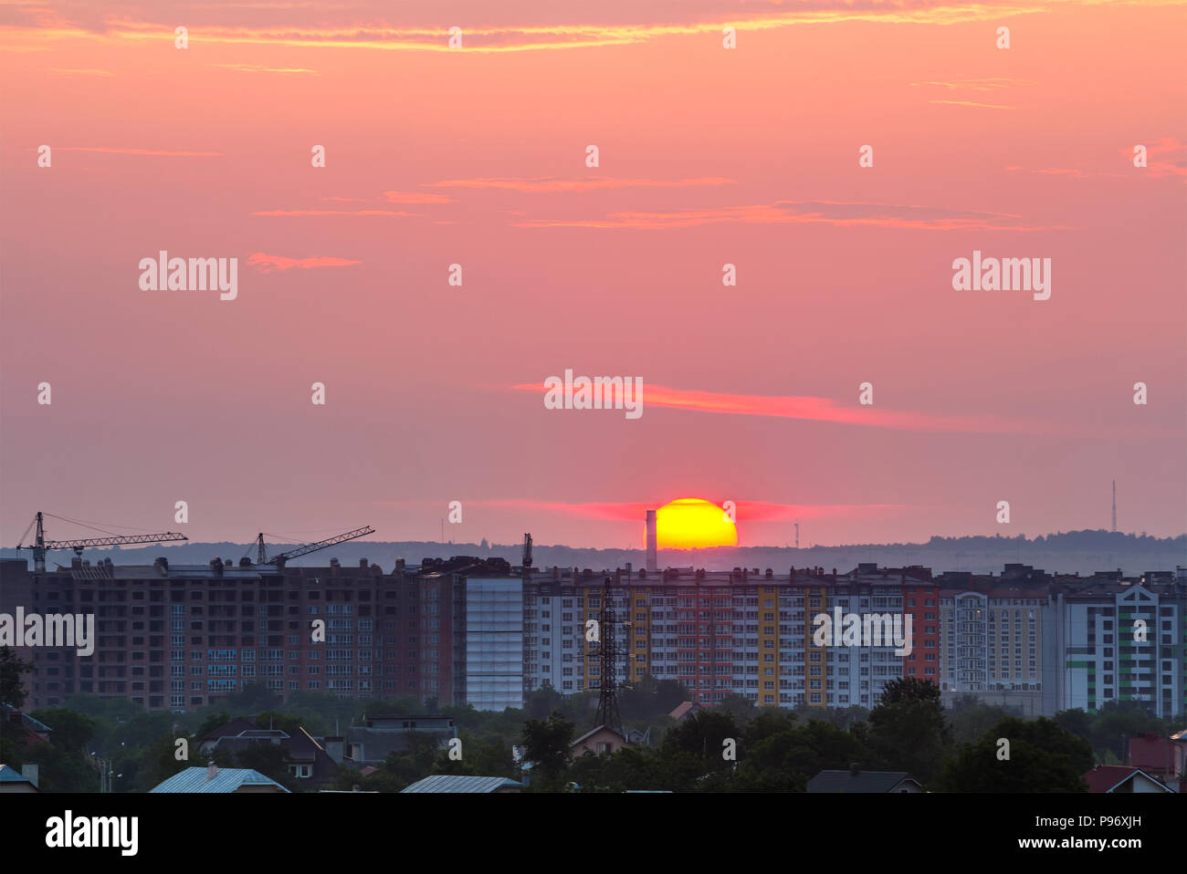 Beautiful sunrise in city suburbs. Big bright white and yellow sun over ...