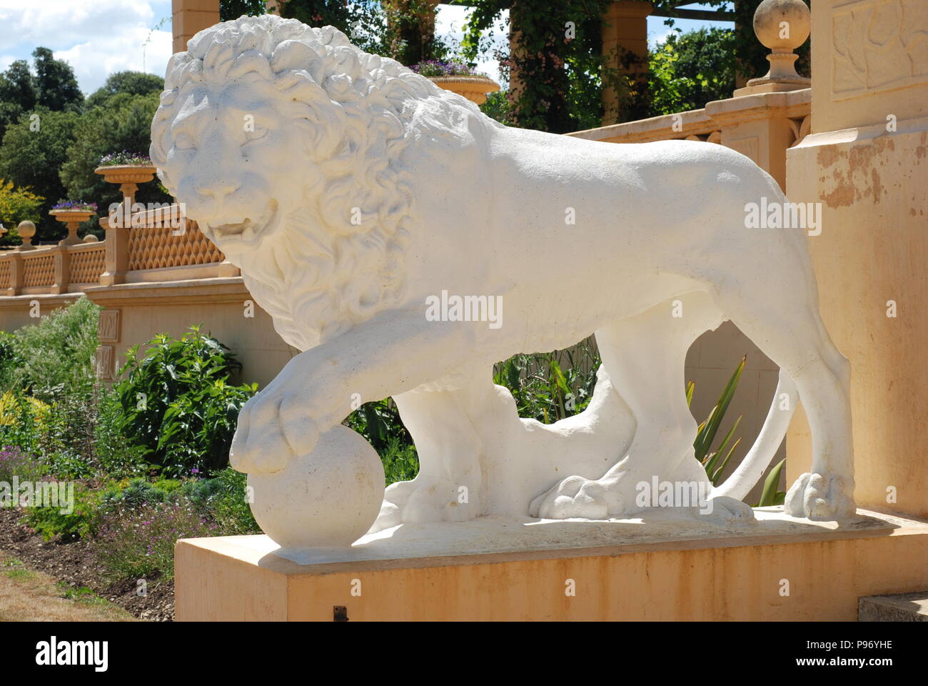 a white stone lion with a ball Stock Photo - Alamy