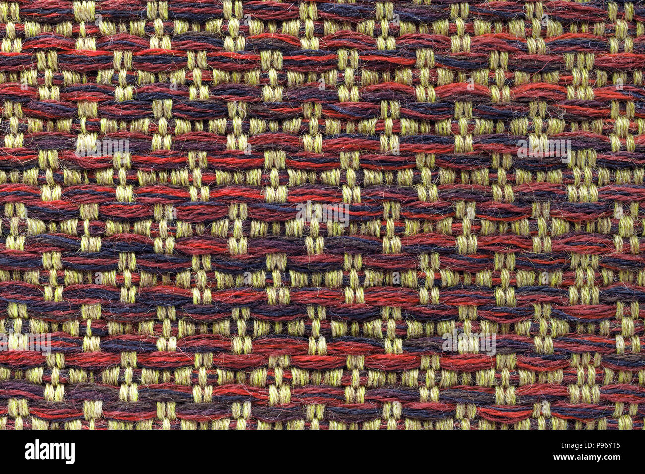 Colorful red-orange hand weaving matting tweed fabric texture. Closeup ...