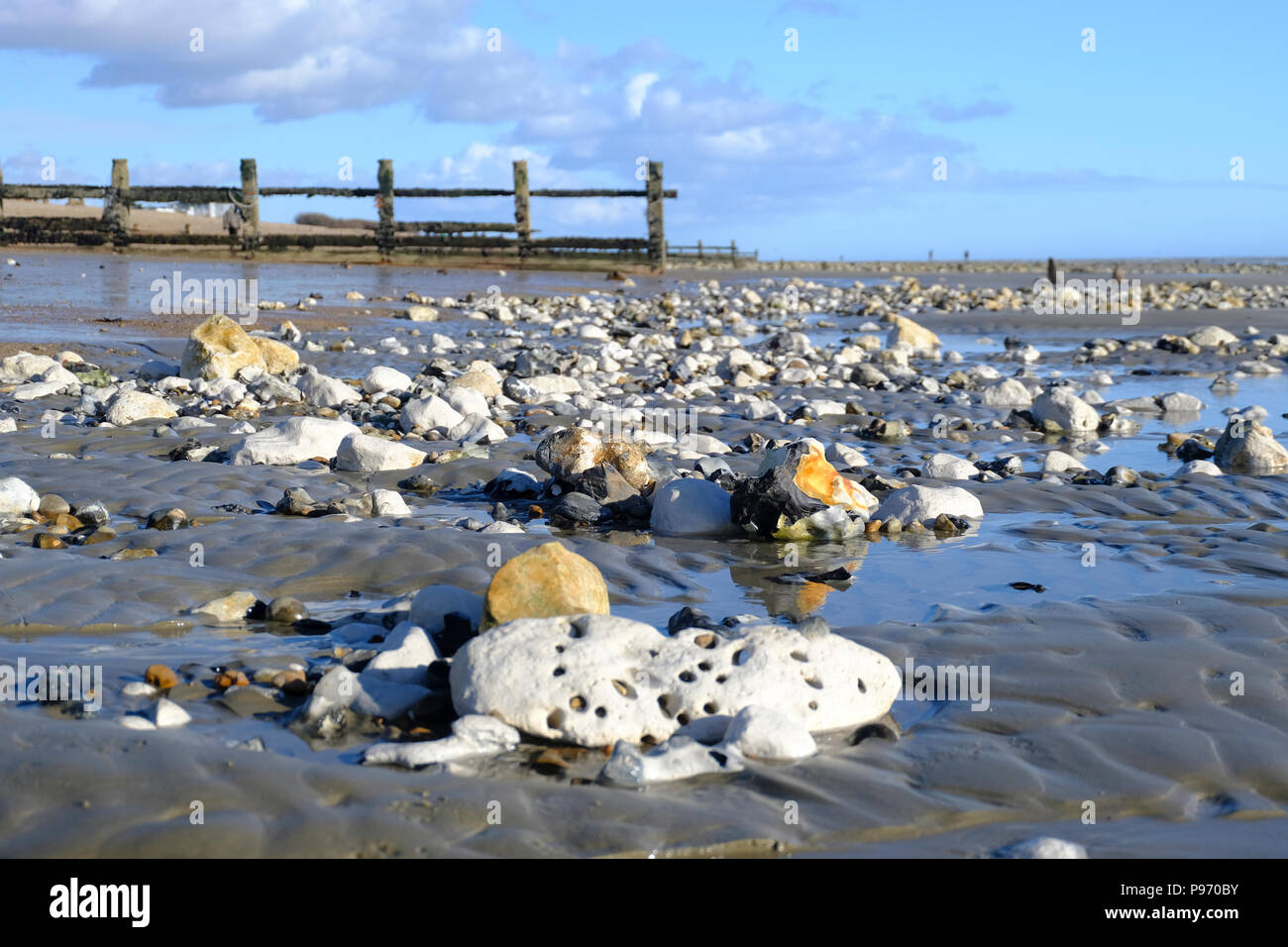 East Preston, UK. Low angle image of beach when tide is out revealing ...
