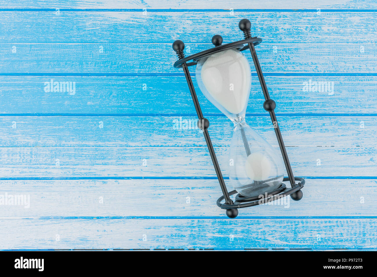 Hourglass blue background hi-res stock photography and images - Alamy