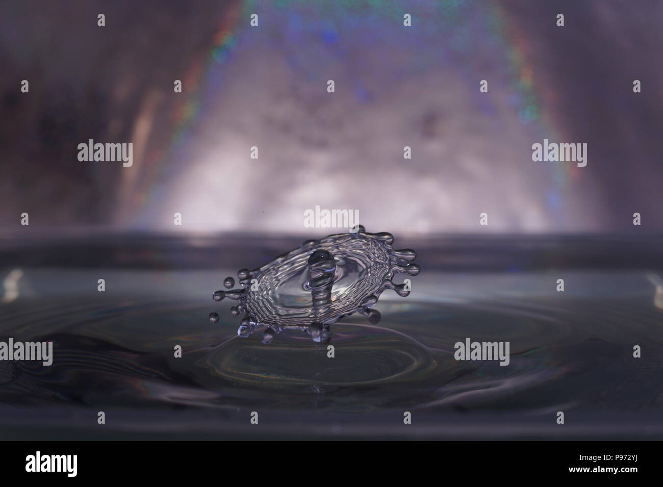 A photo of two water droplets falling into water Stock Photo - Alamy