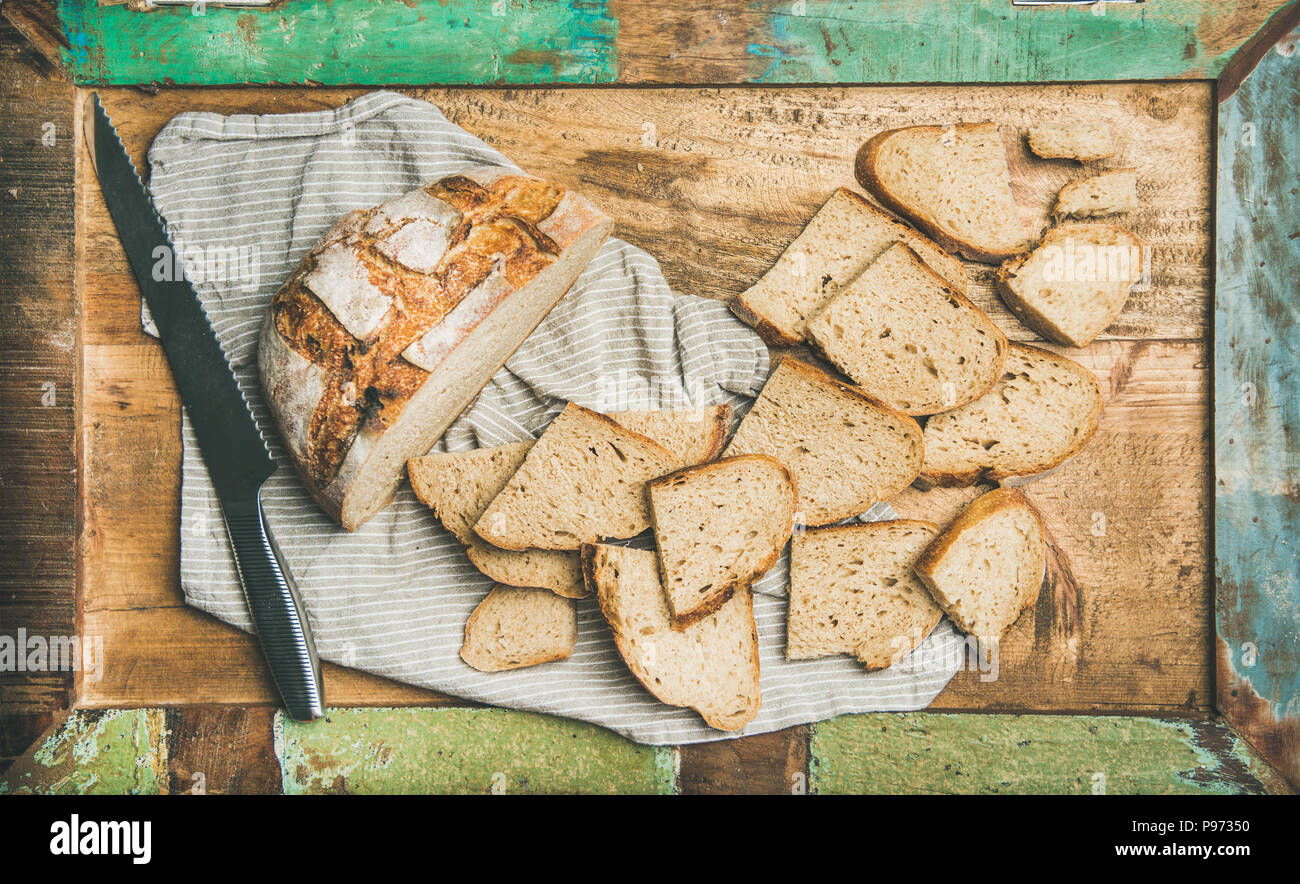 Flat-lay of sourdough wheat bread cut in slices in tray Stock Photo - Alamy