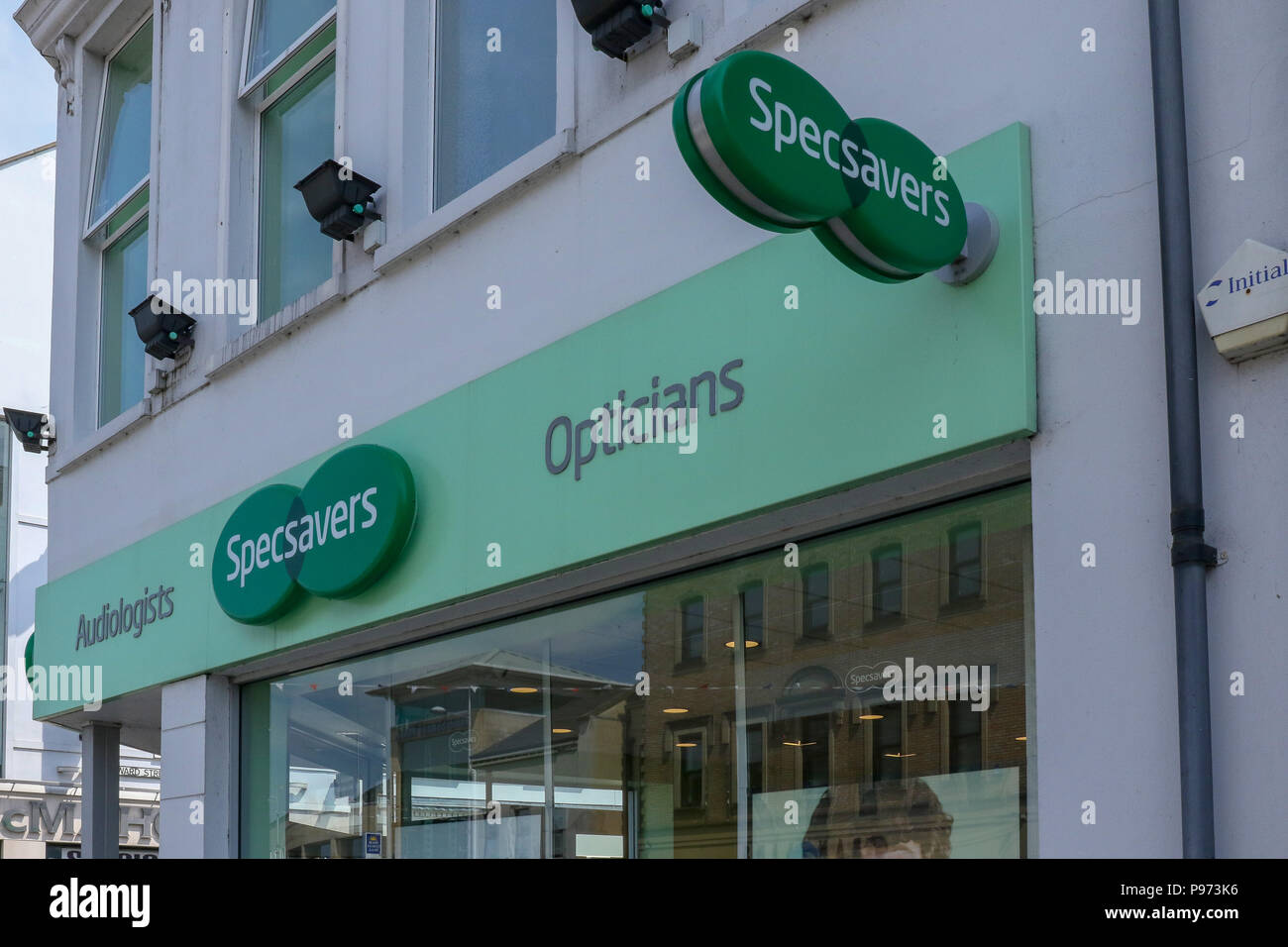 Front of Specsavers opticians shop on the corner of a town centre main ...