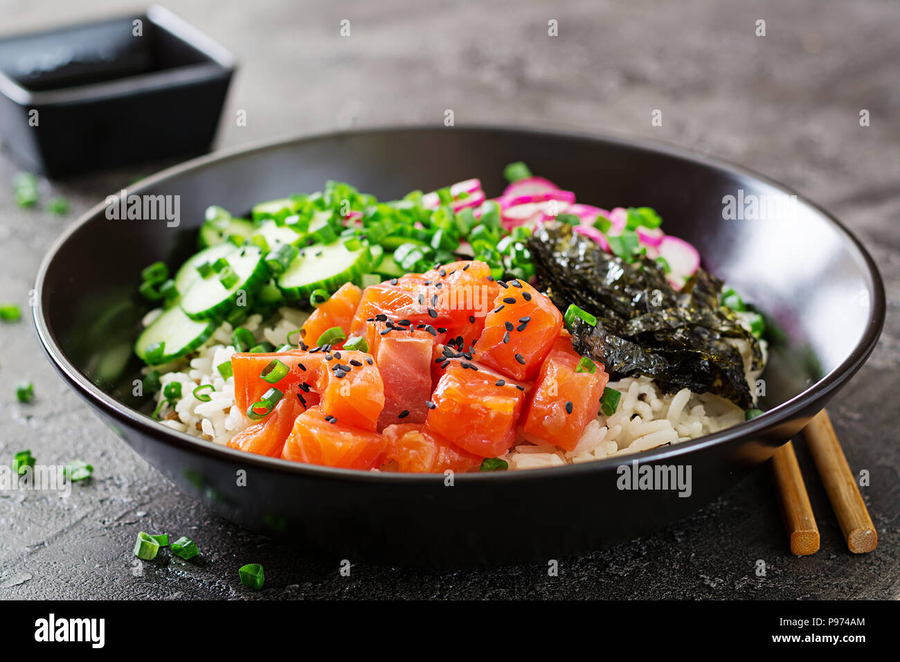 Hawaiian salmon fish poke bowl with rice, radish,cucumber, tomato ...
