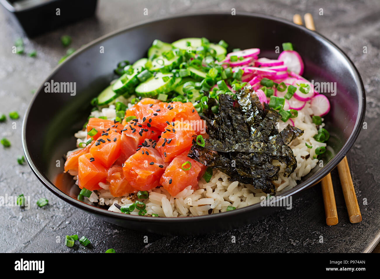 Hawaiian salmon fish poke bowl with rice, radish,cucumber, tomato ...