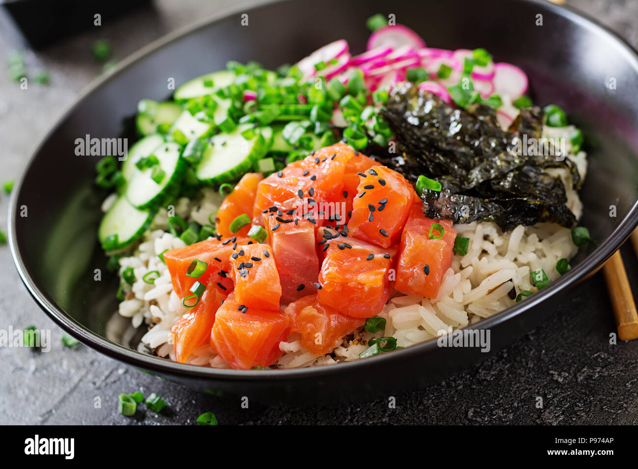 Hawaiian salmon fish poke bowl with rice, radish,cucumber, tomato ...