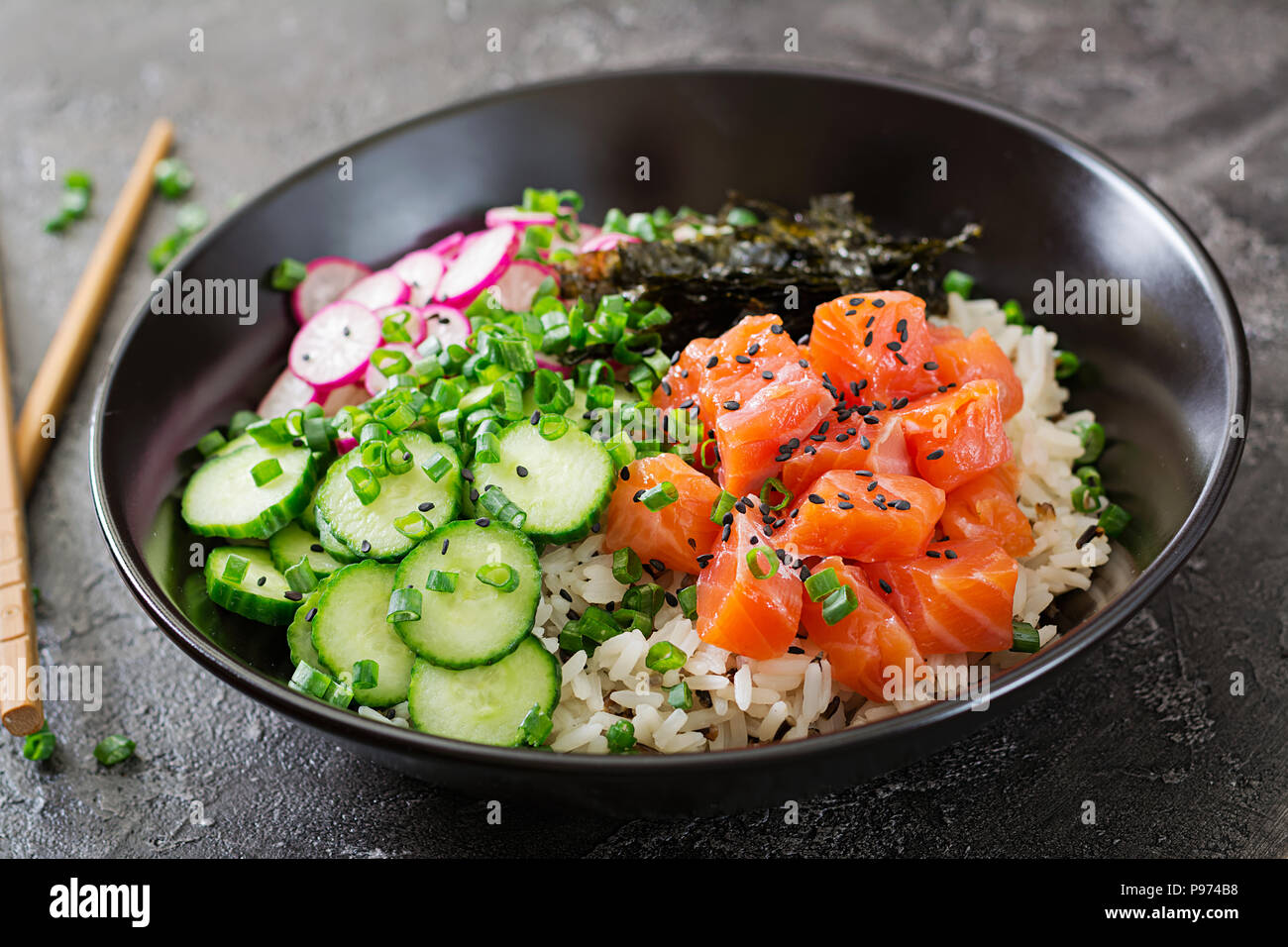 Hawaiian salmon fish poke bowl with rice, radish,cucumber, tomato ...