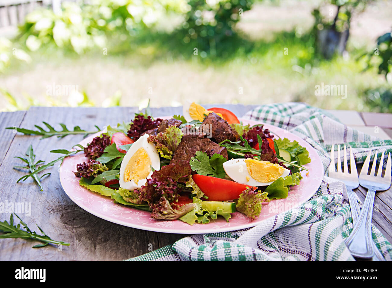 Warm salad from chicken liver, tomato, cucumber and eggs. Healthy ...