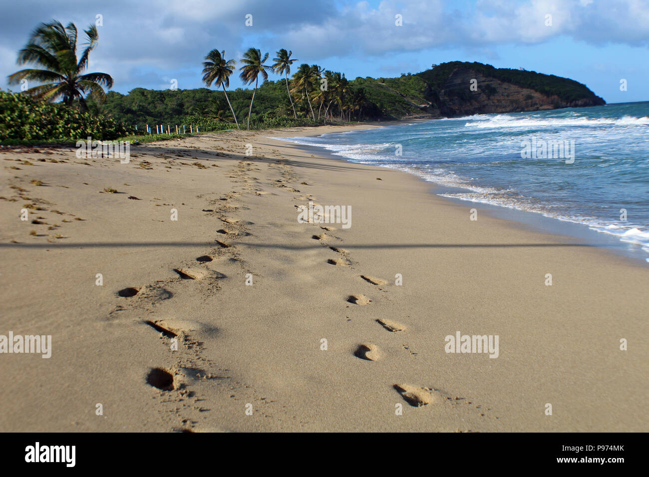 Two sets of footprints in the sand Stock Photo - Alamy