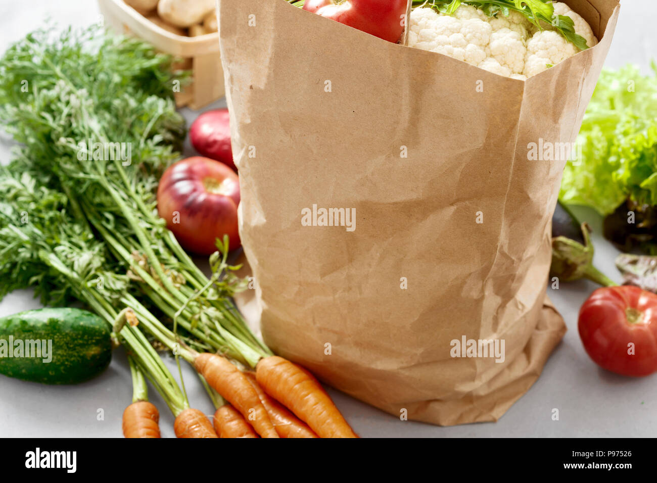 Paper bag with various vegetables on gray background Stock Photo - Alamy