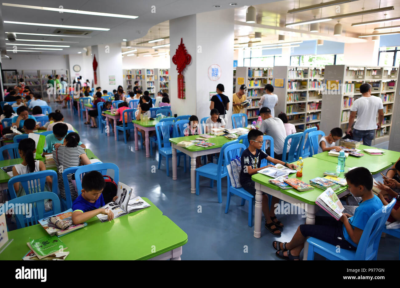 Haikou, China's Hainan Province. 15th July, 2018. Adults and children ...