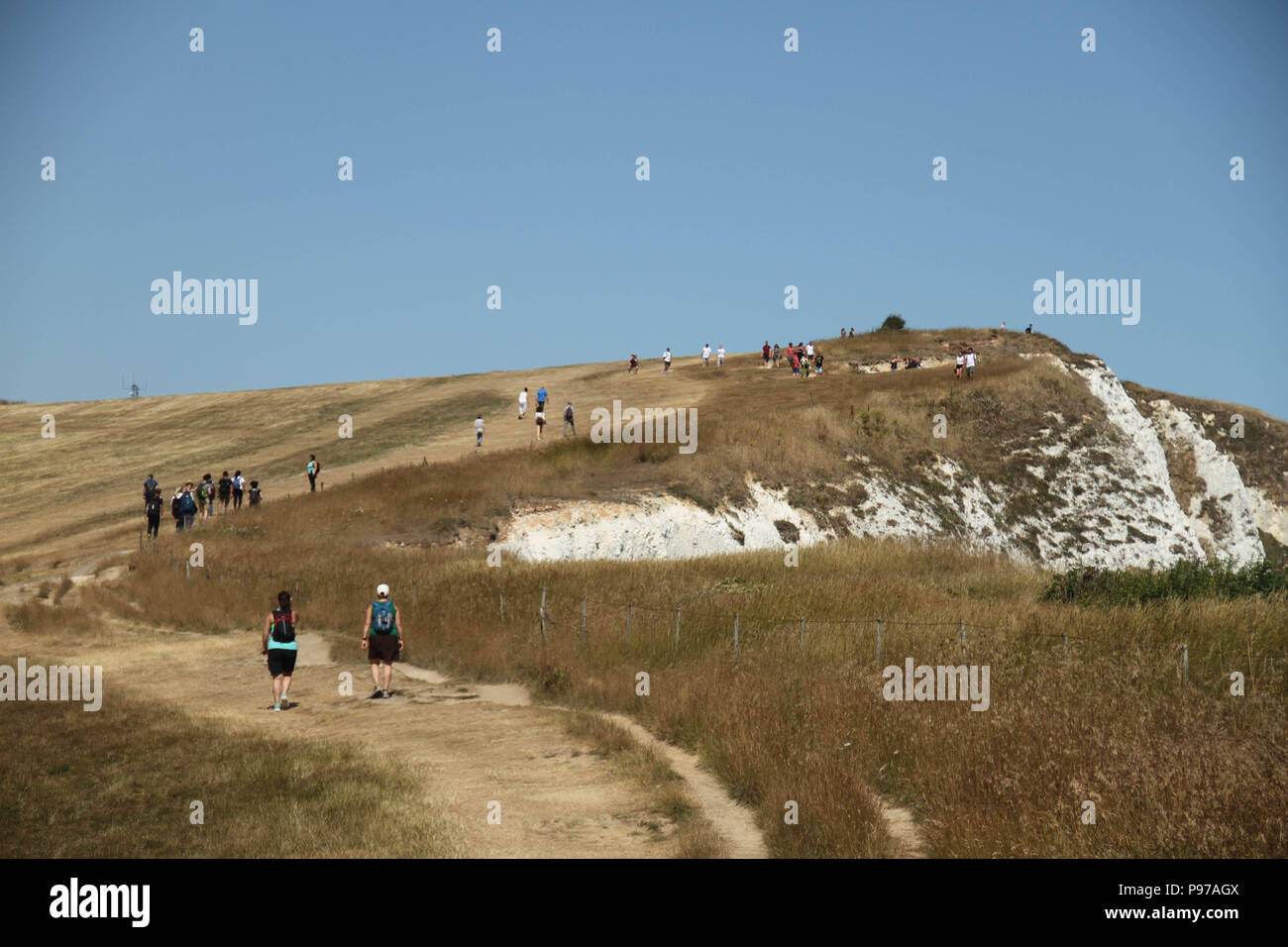 Beachy Head, UK - July 14 2018: Tourists walk on the hilltop of the ...