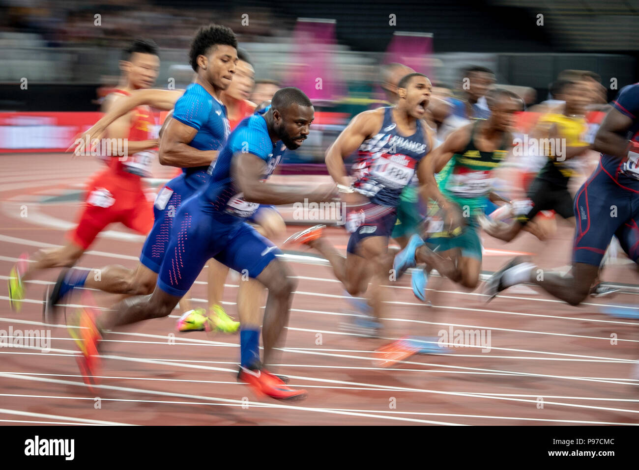 London, UK. 14th July 2018. Male sprinters conduct a baton change in ...
