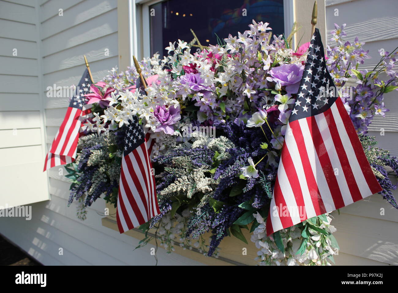 Fourth of July celebration flags planted on a windowsill of the ...