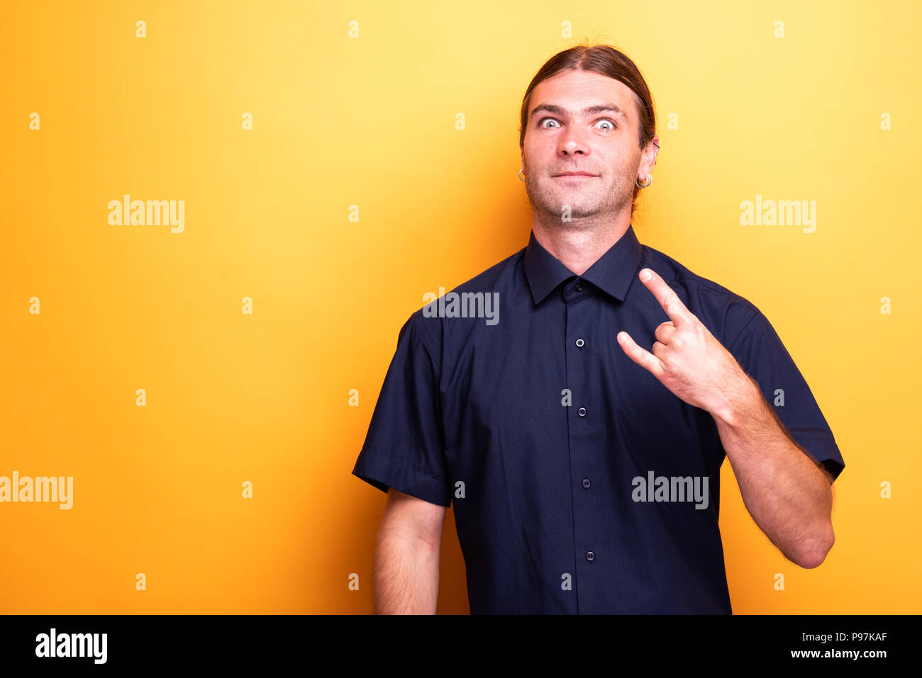 Fun male person showing rock sign Stock Photo - Alamy