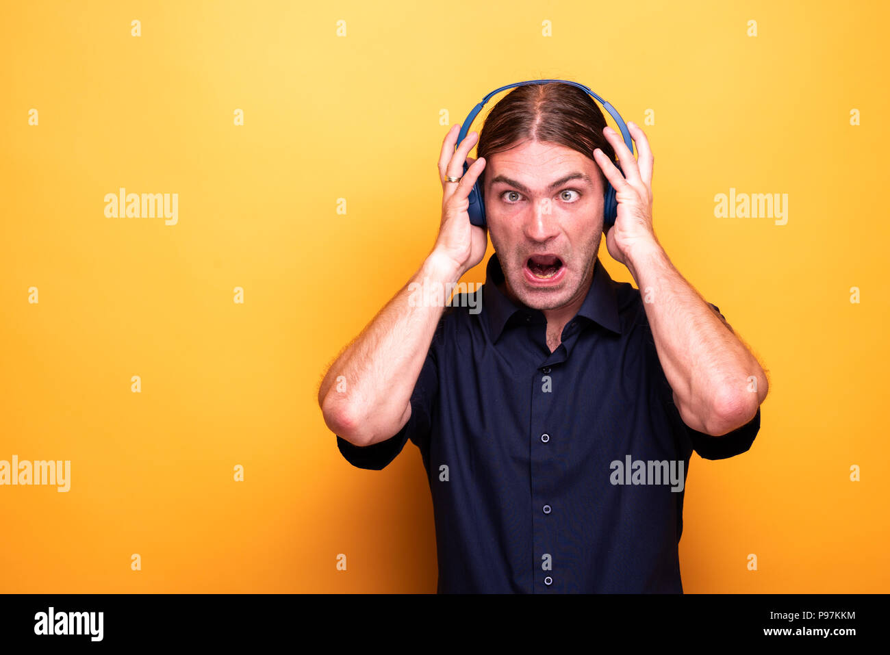 Crazy face of crosseyed man wearing headphones Stock Photo - Alamy