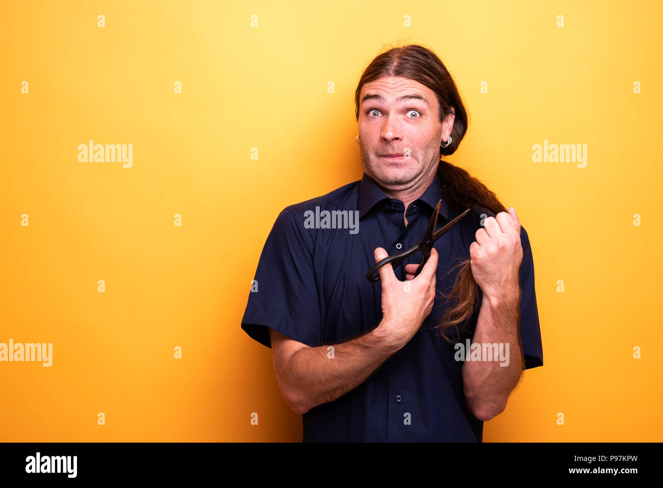 Scared funny face while cutting hair with scissors Stock Photo - Alamy