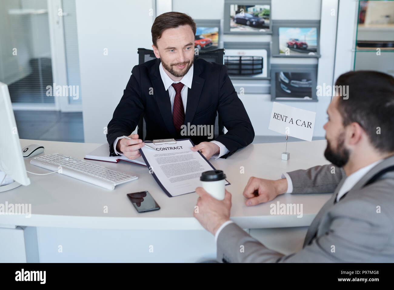 Salesman with contract of rent a car Stock Photo - Alamy