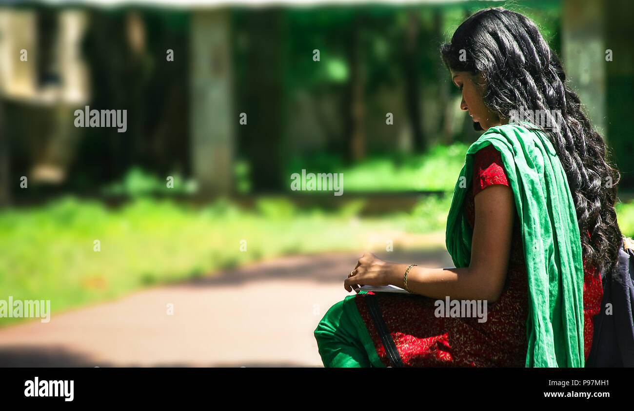 smart looking female student reading book Stock Photo - Alamy