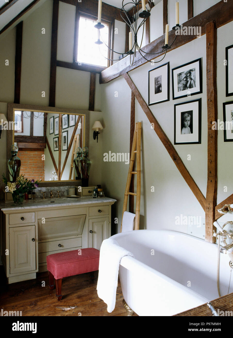Mirror above white dressing table in country bathroom with black+white ...