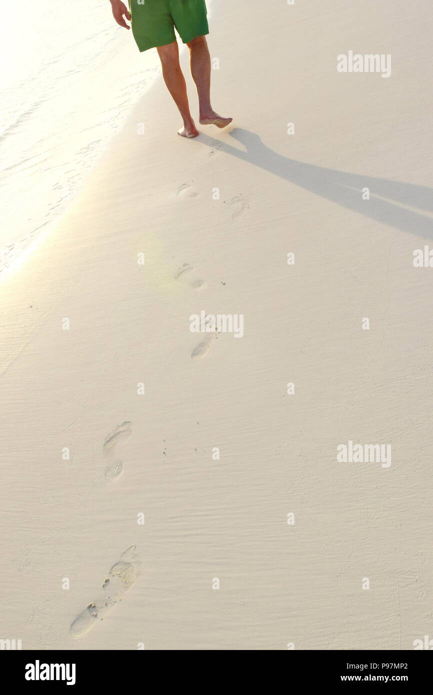 Senior man walking on the Treasure Cay beach early morning on the ...