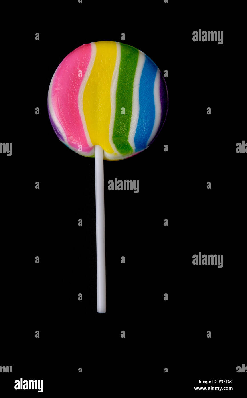 Bright colored striped lollipop on black background Stock Photo - Alamy