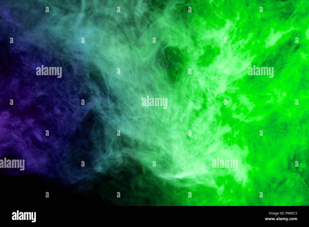 Colorful green and blue smoke on a black isolated background ...