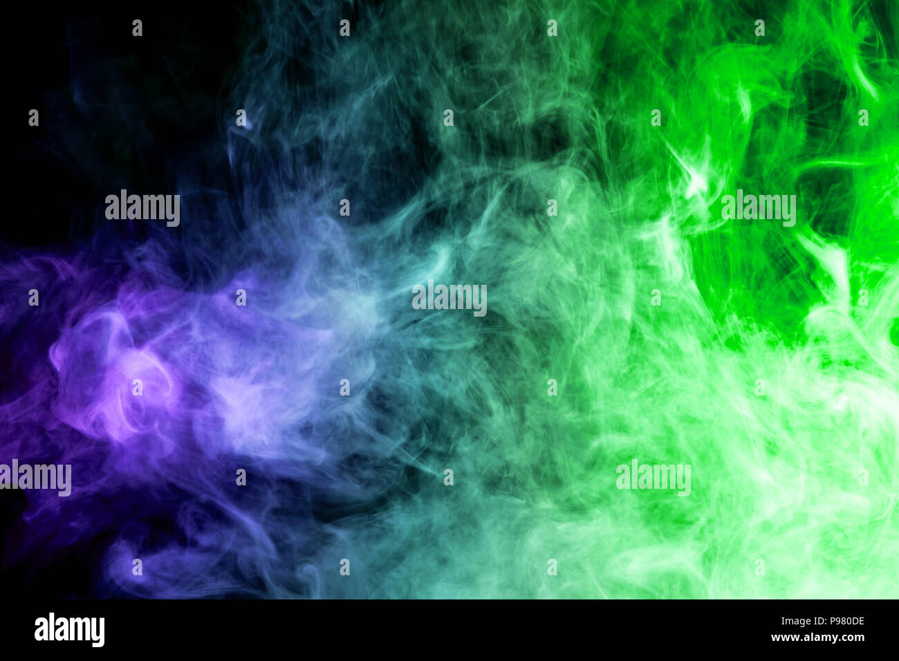 Dense multicolored smoke of blue and green colors on a black isolated ...